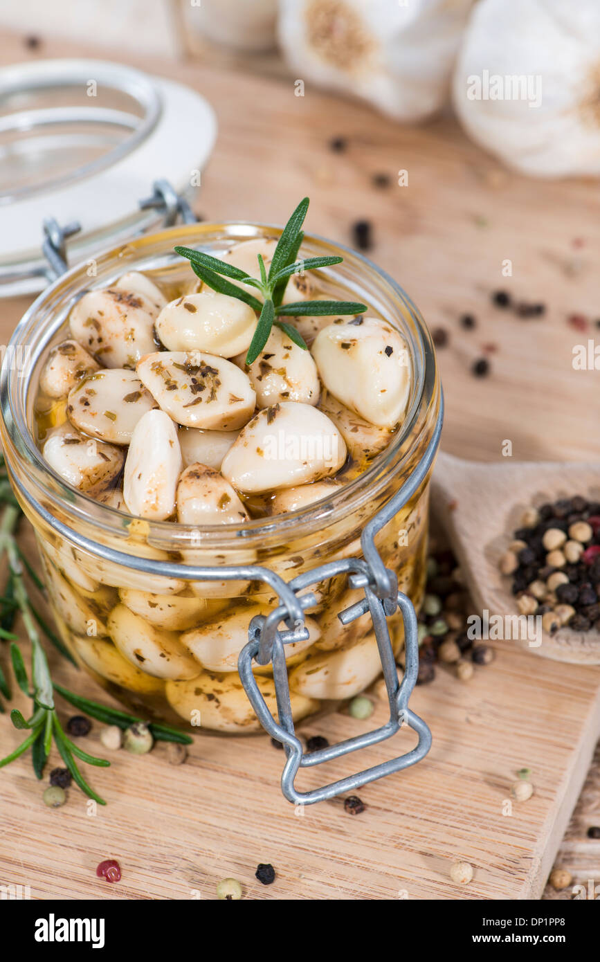 Preserved Garlic with fresh herbs on vintage background Stock Photo - Alamy