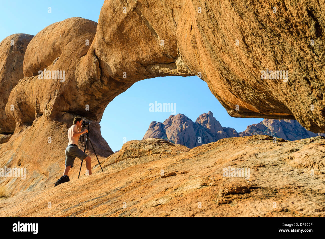 Photographer at a rock bridge, Damaraland, Namibia Stock Photo - Alamy