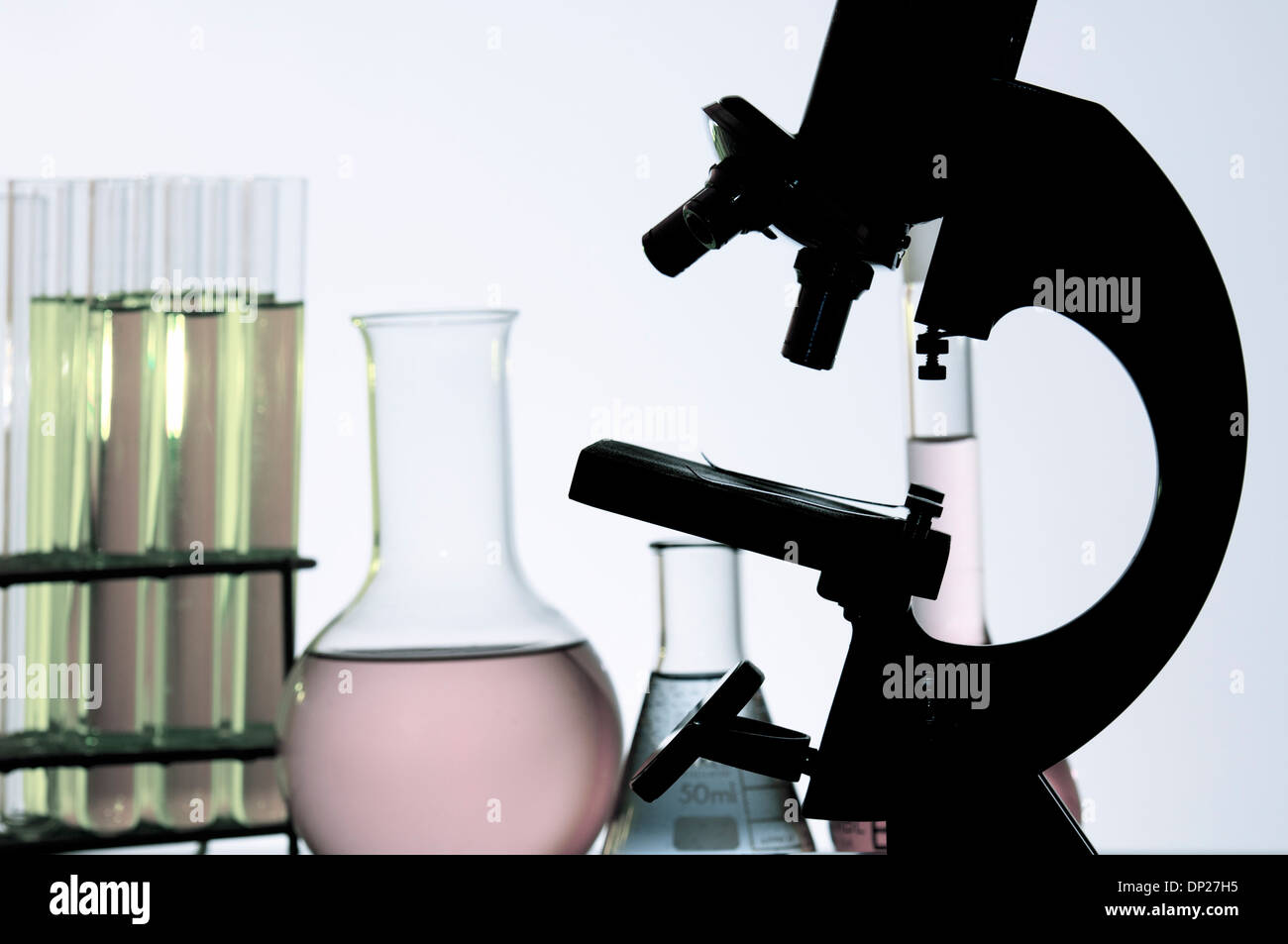 research microscope and laboratory bottles with colored liquid Stock ...