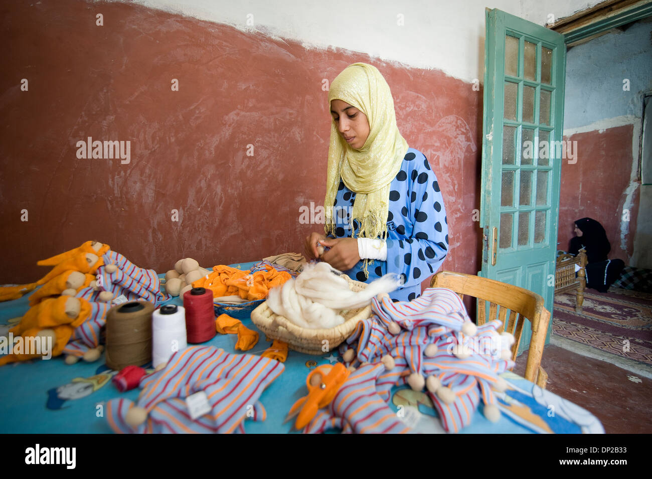 Bilbeis, Egypt: Young Egyptian woman working as a seamstress at home ...