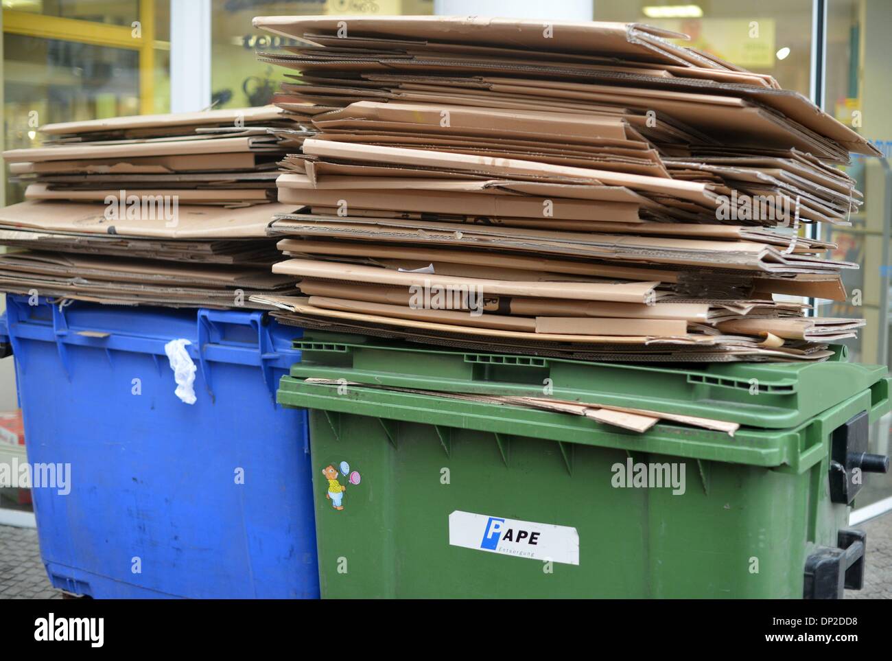 Garbage cans with paperboard are staying on the street to get picked up ...