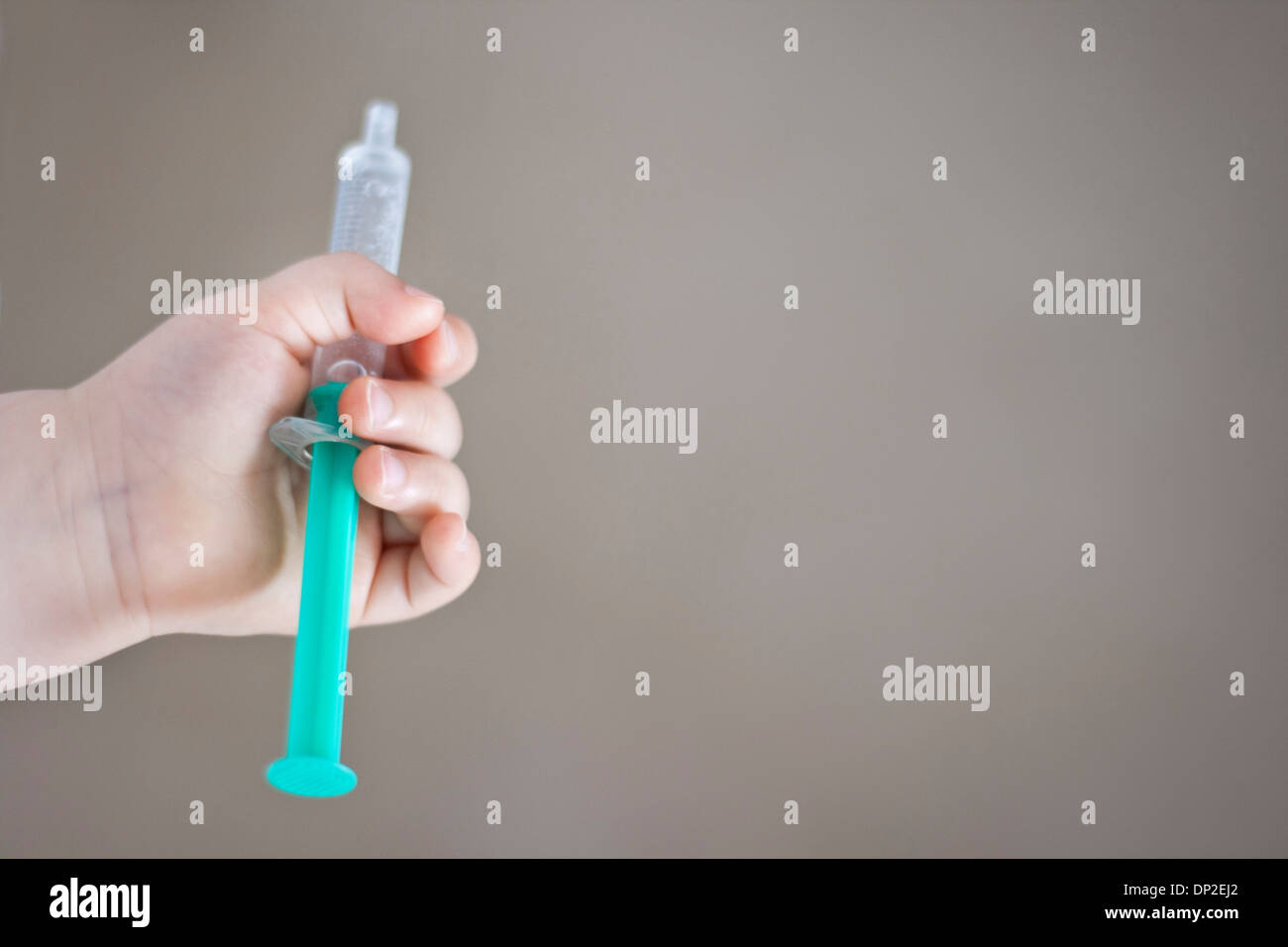 Baby's hand holding a injection in a pediatric hospital Stock Photo - Alamy