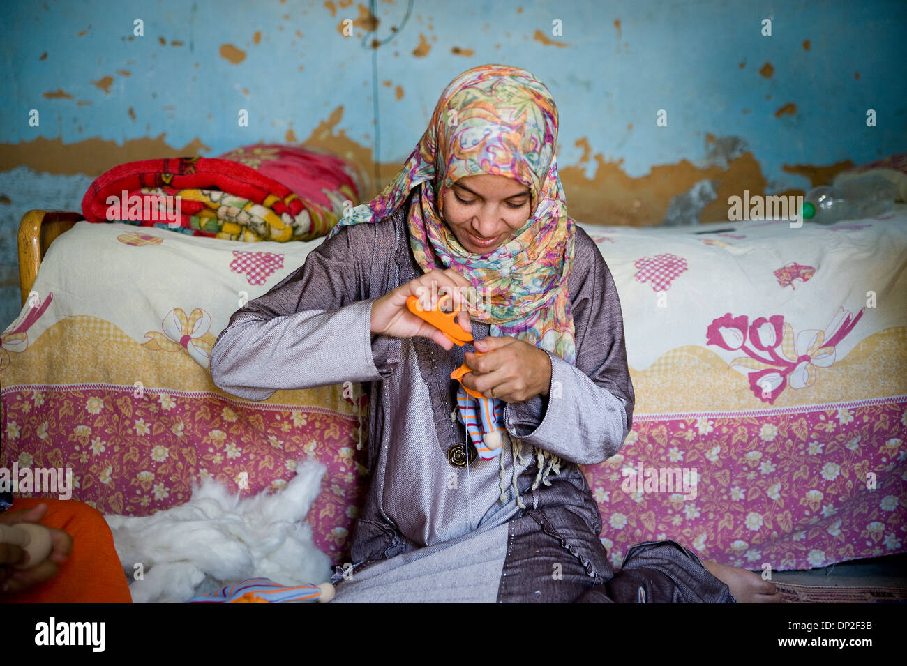 Bilbeis, Egypt: Young Egyptian woman working as a seamstress at home ...