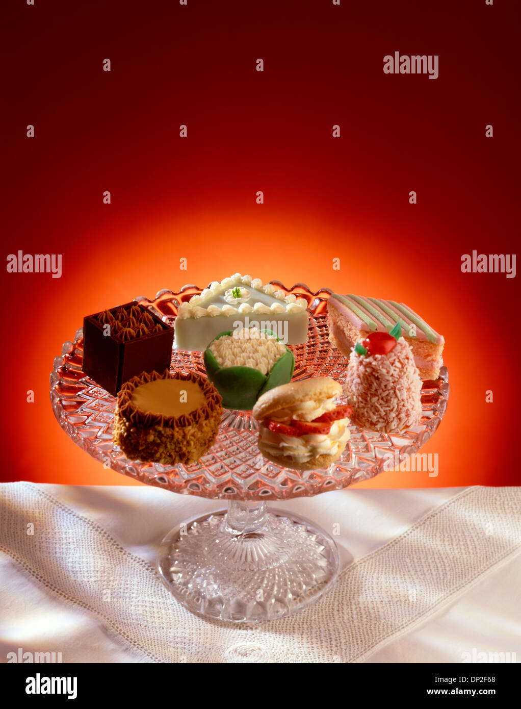 fancy cakes on a glass cake stand Stock Photo - Alamy