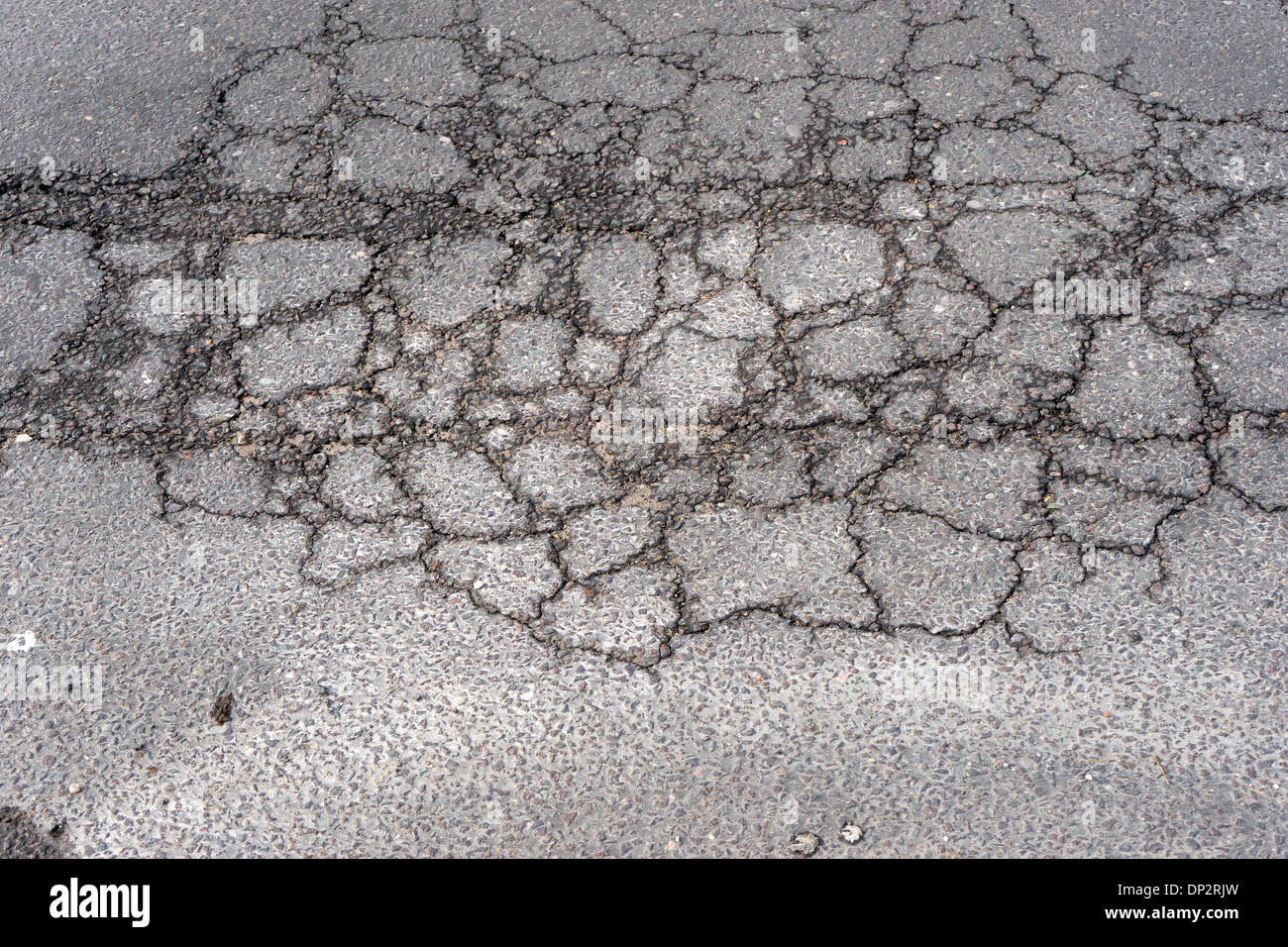 UK tarmac road surface breaking up Stock Photo - Alamy