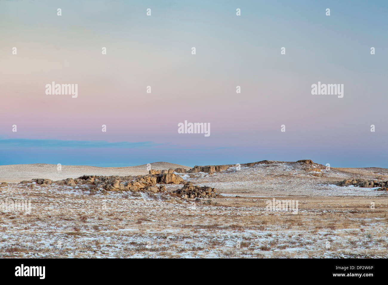 calm winter dusk over prairie in northern Colorado with rock ...