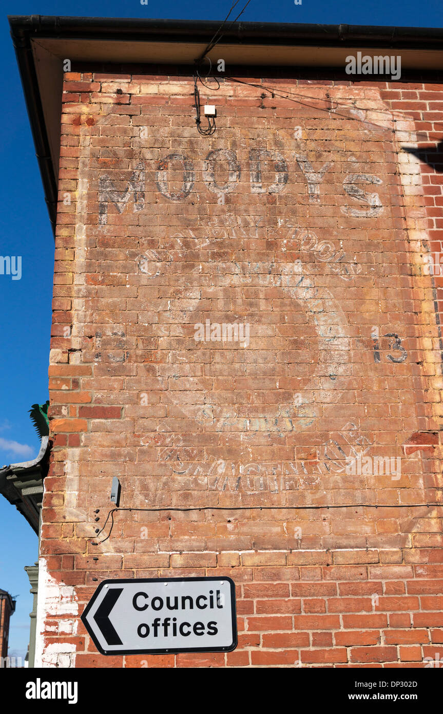 Faded and feint remains of old hand painted advertising signs on the ...