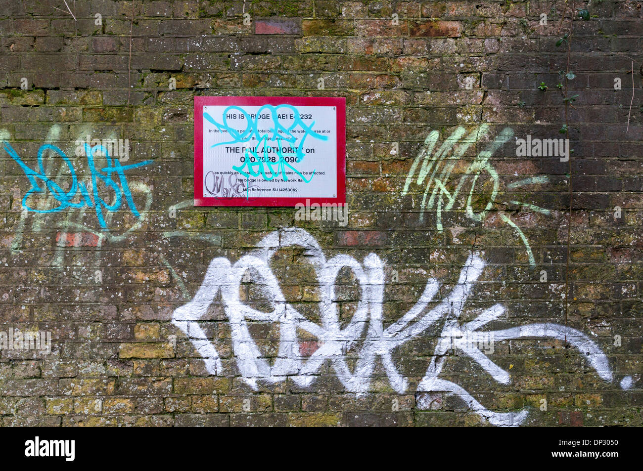 Graffiti on brick wall and sign Stock Photo - Alamy