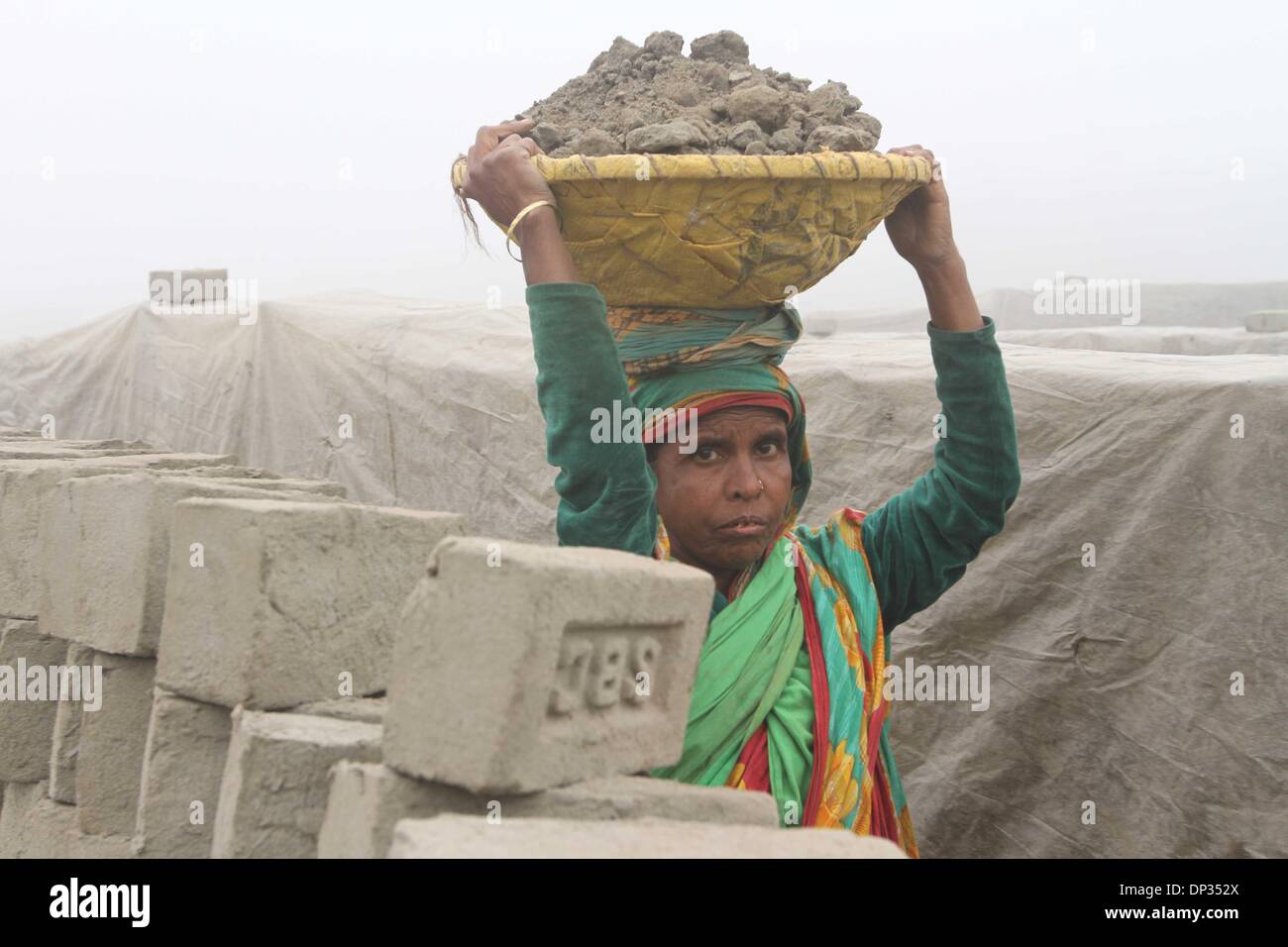 Bangladeshi woman daily laborer working winter morning in a brickfield ...