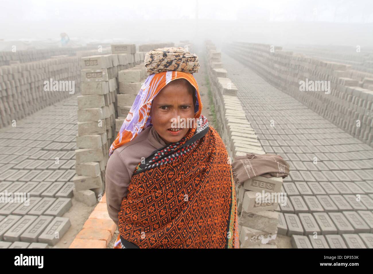 Bangladeshi woman daily laborer working winter morning in a brickfield ...