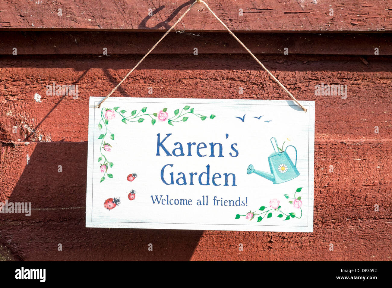 Small welcome sign hanging on a garden fence Stock Photo - Alamy