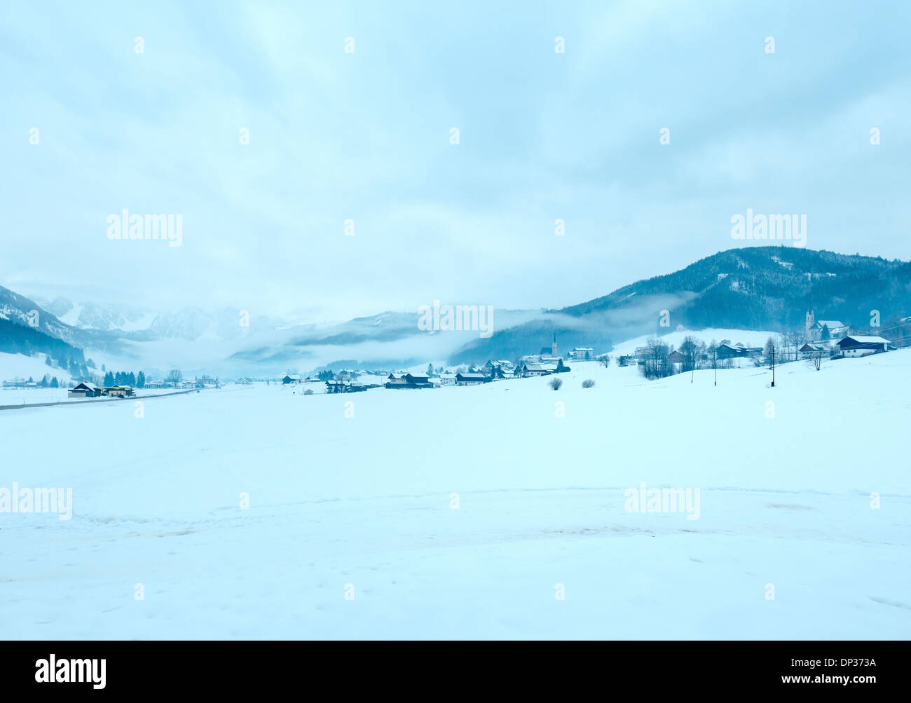 Winter mountain village hazy landscape with low-hanging clouds (Austria ...