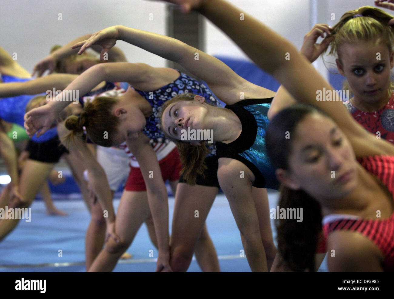 (published 10/17/2003, B-4:2)Alex Tuthill, 15, center, stretches with ...
