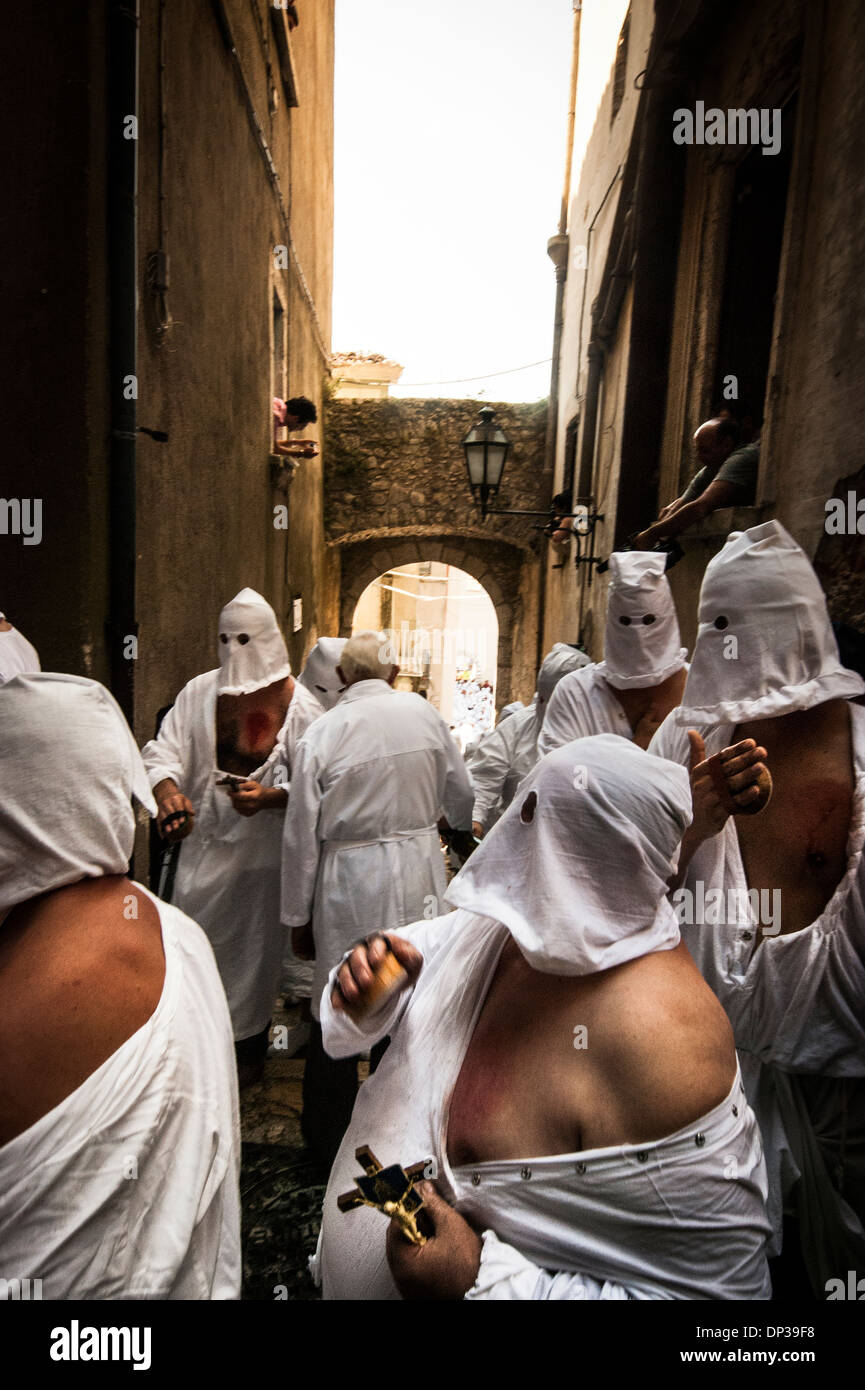 Penitents during the bloody procession for the Assumption of the Virgin ...
