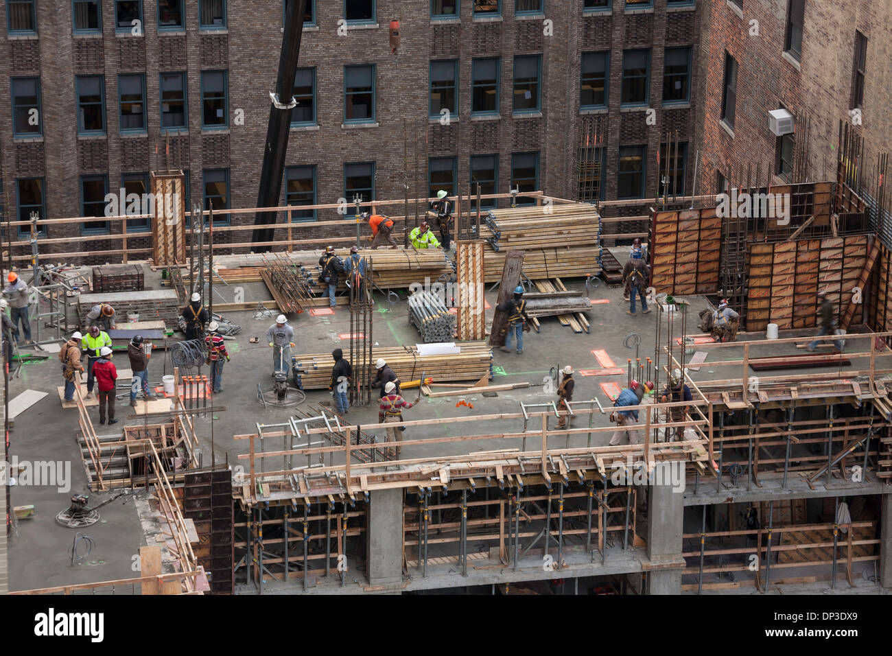 High-rise Building Construction Site with tradesmen, NYC Stock Photo ...