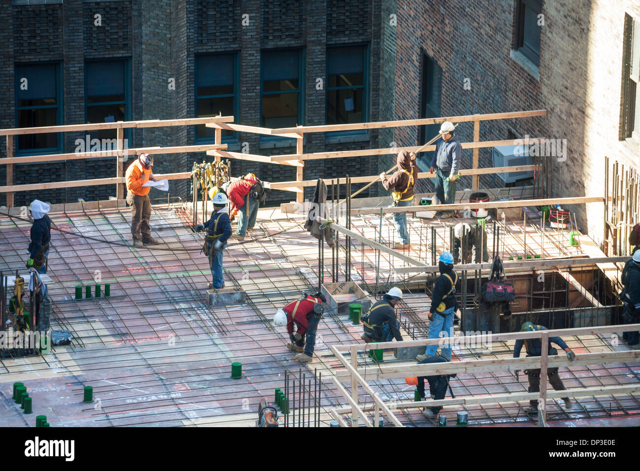 High-rise Building Construction Site with tradesmen, NYC Stock Photo ...