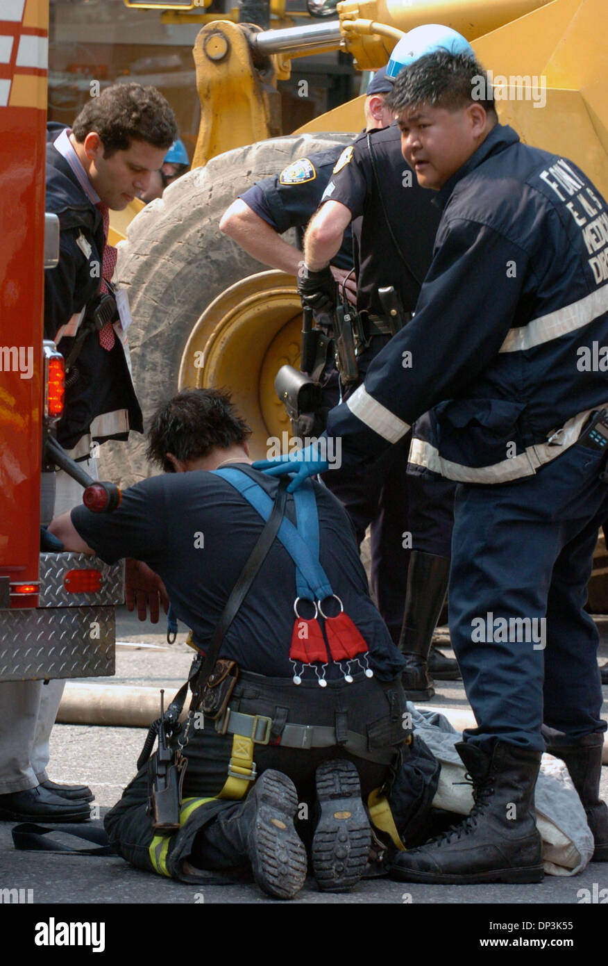 Jul 10, 2006; Manhattan, NY, USA; A firefighter collapses against a ...