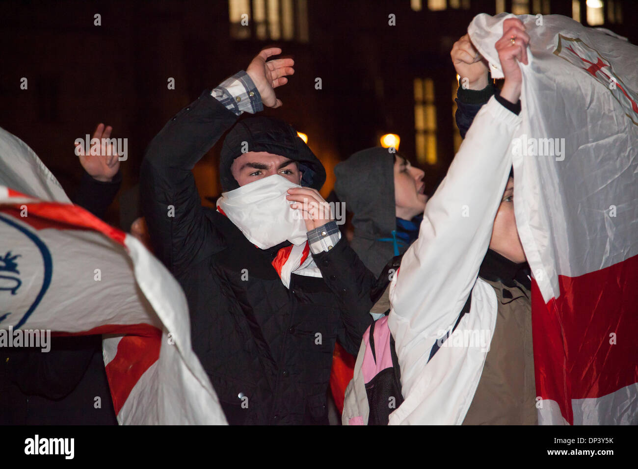 EDL supporters chanting and carrying red and white flags. Approximately ...