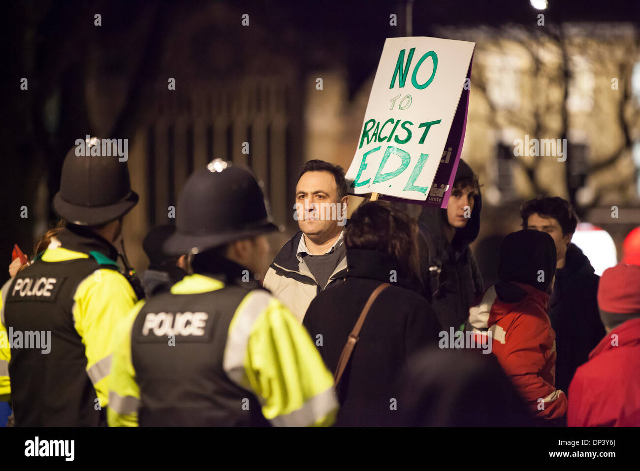 An anti-EDL protester holds a placard reading 'no racist EDL' as part ...