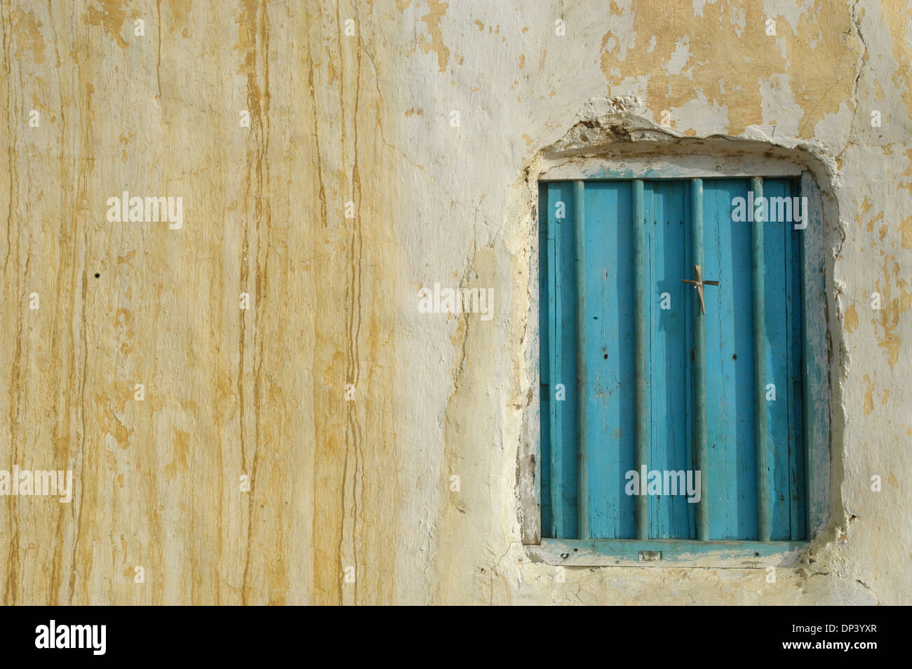 A blue window decorates a mud house in Paraguana Peninsula, Falcon ...