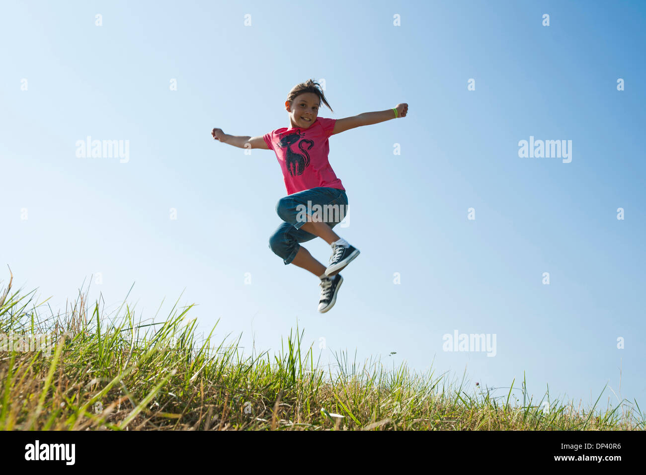 Girl jumping in mid-air over field, Germany Stock Photo - Alamy