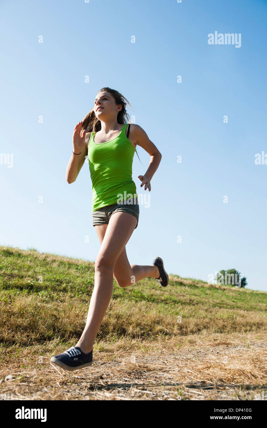 Teenaged girl running in field, Germany Stock Photo - Alamy