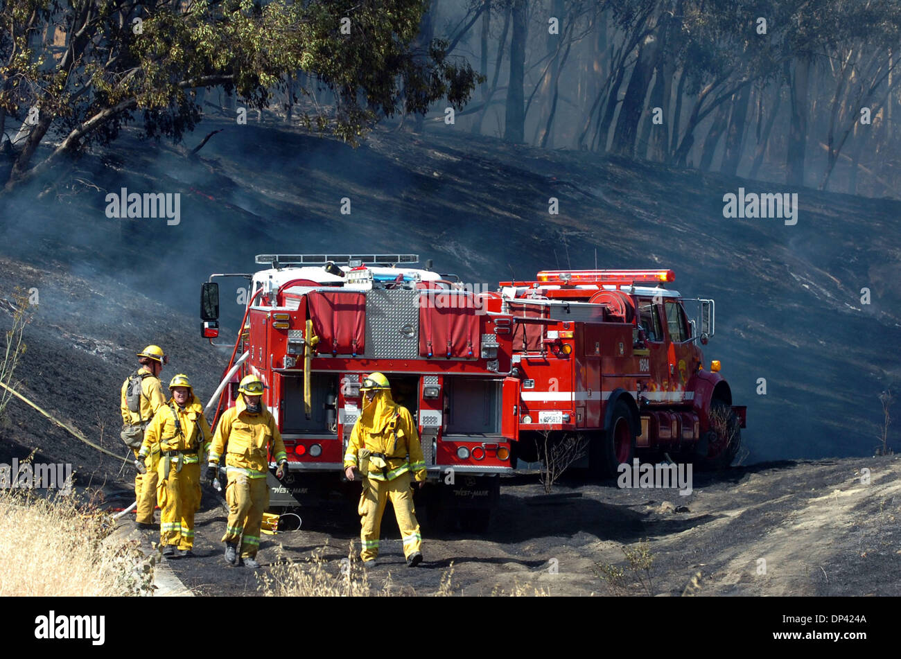 Jul 21, 2006; Orinda, CA, USA; Firefighters head back down the hill ...