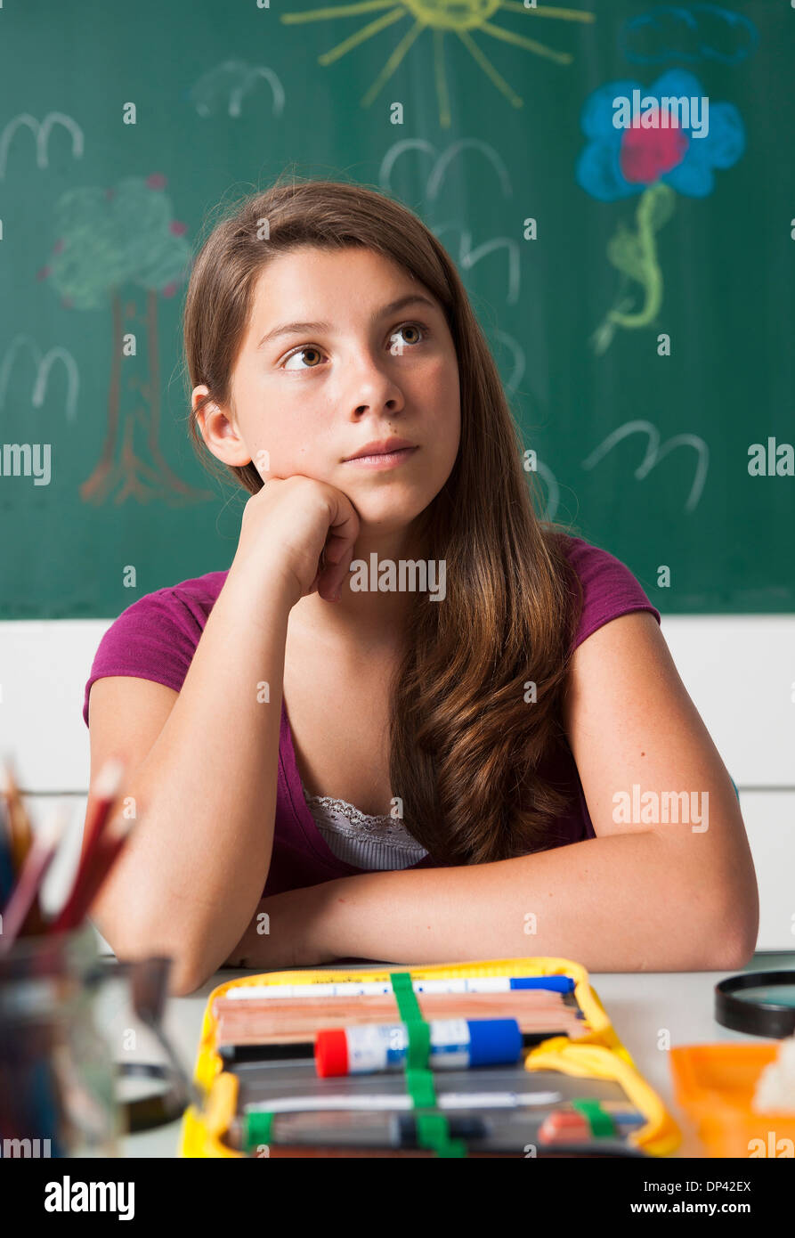 Teenaged girl sitting at desk in classroom, Germany Stock Photo - Alamy