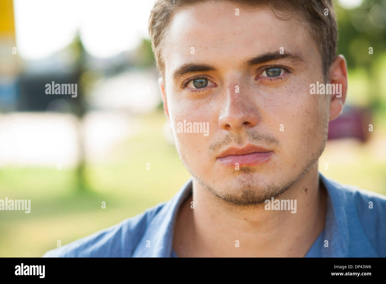 Close-up portrait of young man outdoors, looking at camera, Germany ...