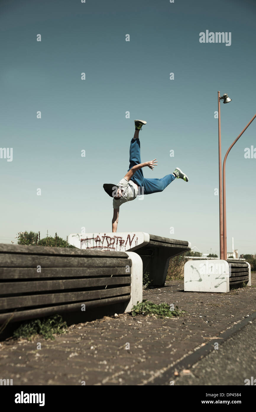 Teenaged boy doing handstand on barrier, freerunning, Germany Stock ...