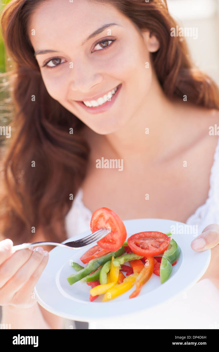 Woman eating a salad Stock Photo - Alamy