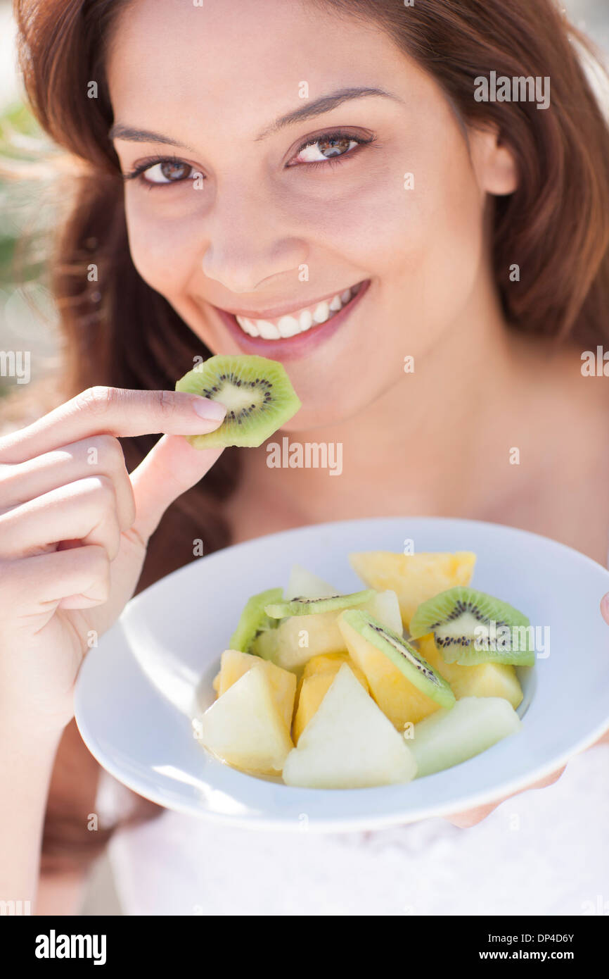 Woman eating fruit Stock Photo - Alamy