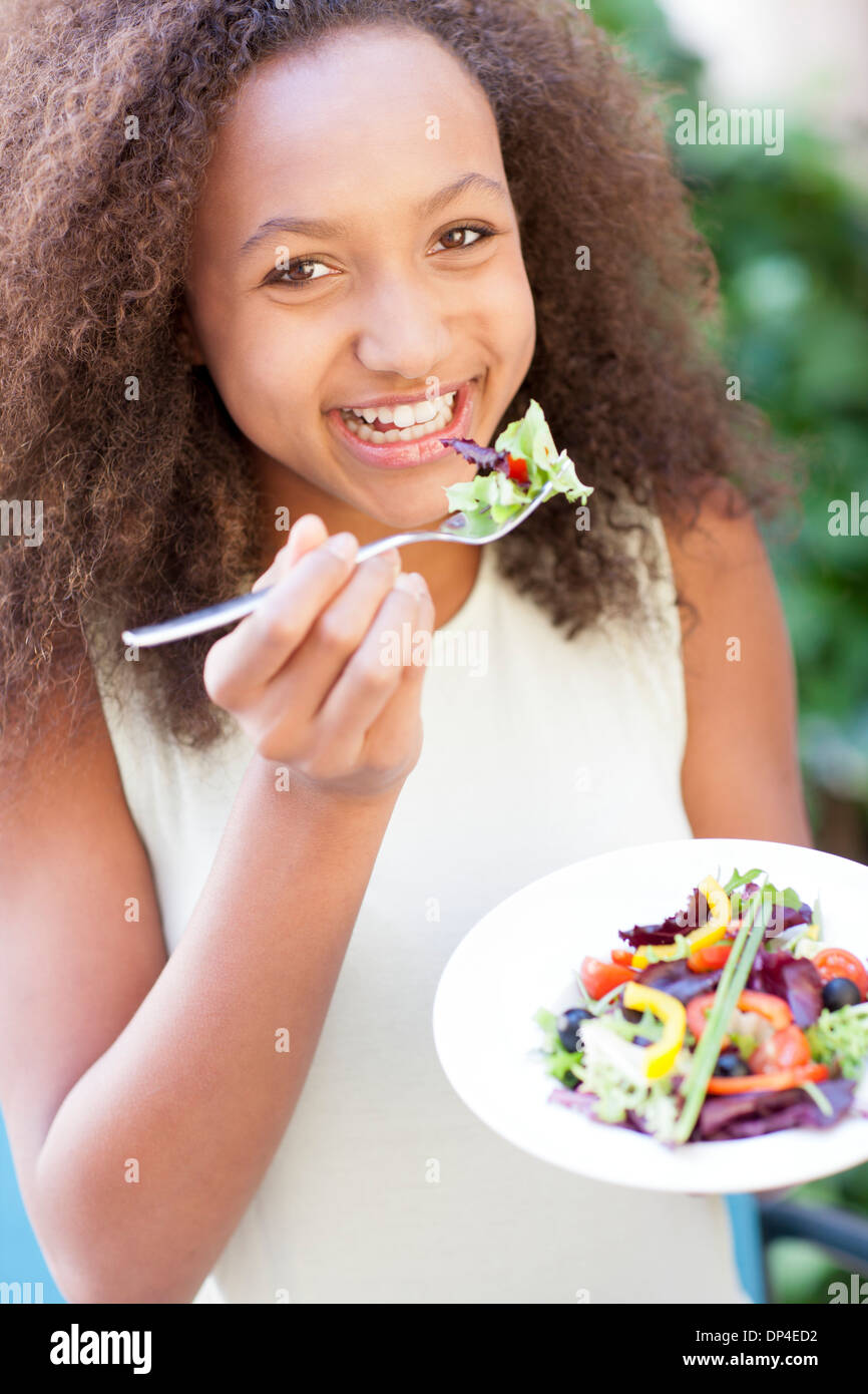 Teenage girl eating a salad Stock Photo - Alamy