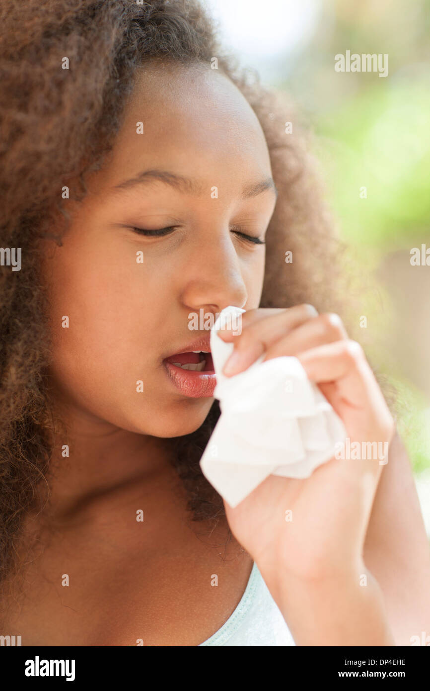 Teenage girl sneezing Stock Photo - Alamy