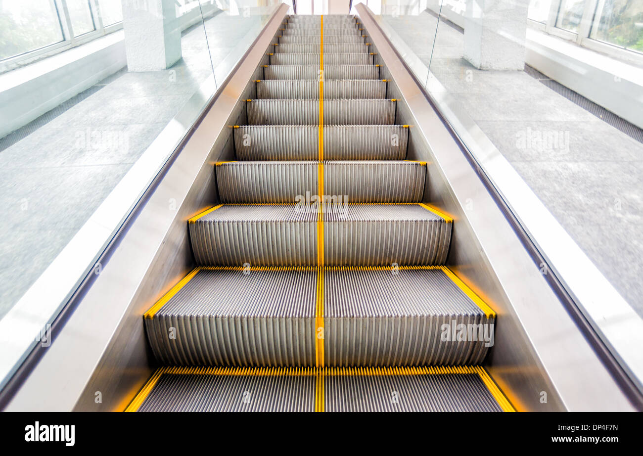 perspective escalators stairway with yellow line Stock Photo - Alamy