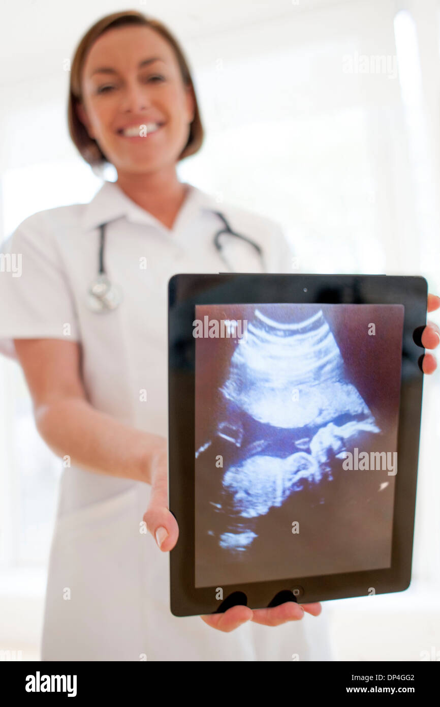Nurse with baby scan Stock Photo - Alamy