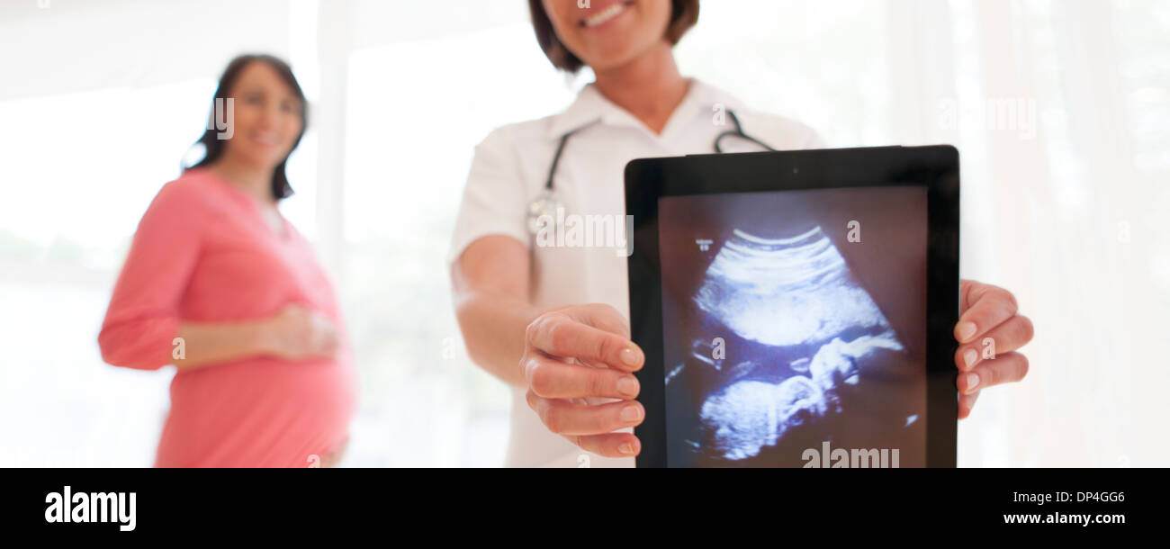 Nurse with baby scan Stock Photo - Alamy