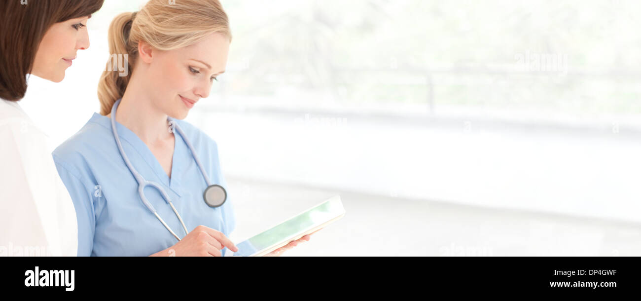 Two people looking at a computer hi-res stock photography and images ...