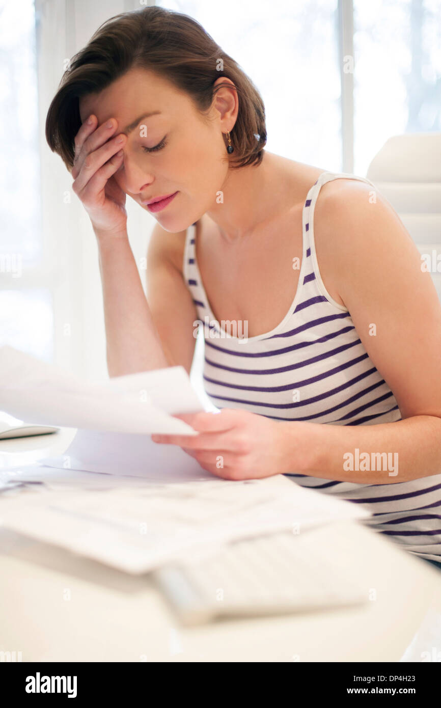 Woman looking at paperwork worried hi-res stock photography and images ...