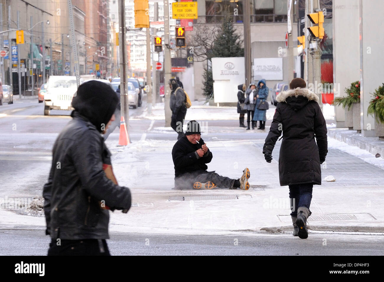 Toronto, Canada. 7th Jan 2014. A homeless man sits on a subway ...