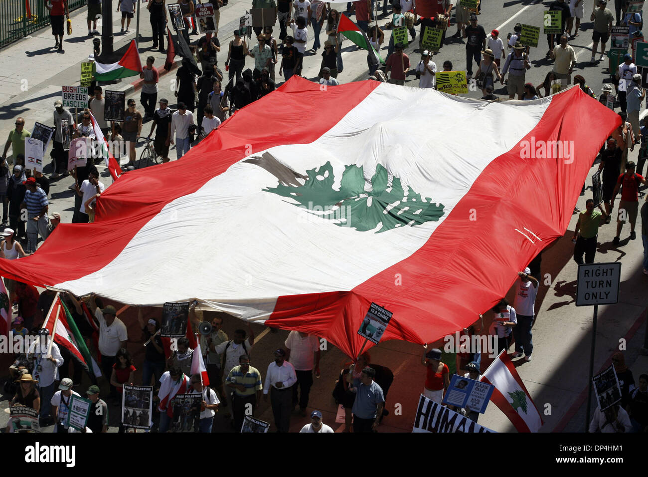 Aug 12, 2006; Los Angeles, CA, USA; Protesters carry a Lebanese flag as ...