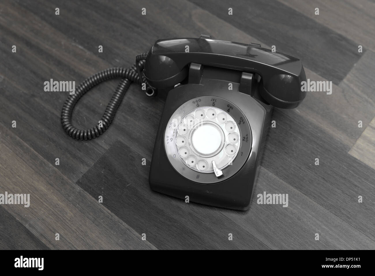A vintage telephone isolated on a wooden floor Stock Photo - Alamy