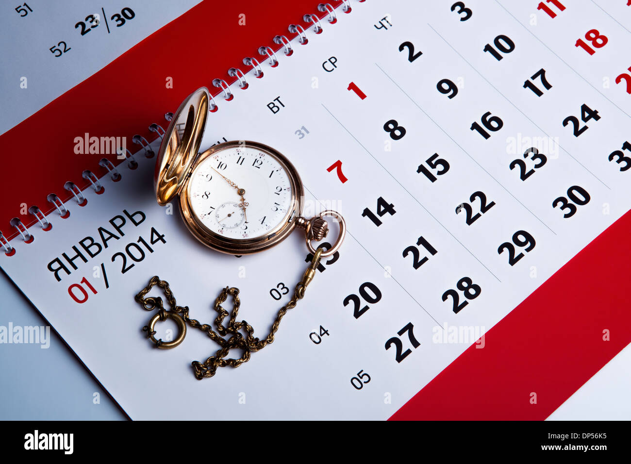 Gold pocket watch with wall calendar close-up Stock Photo - Alamy