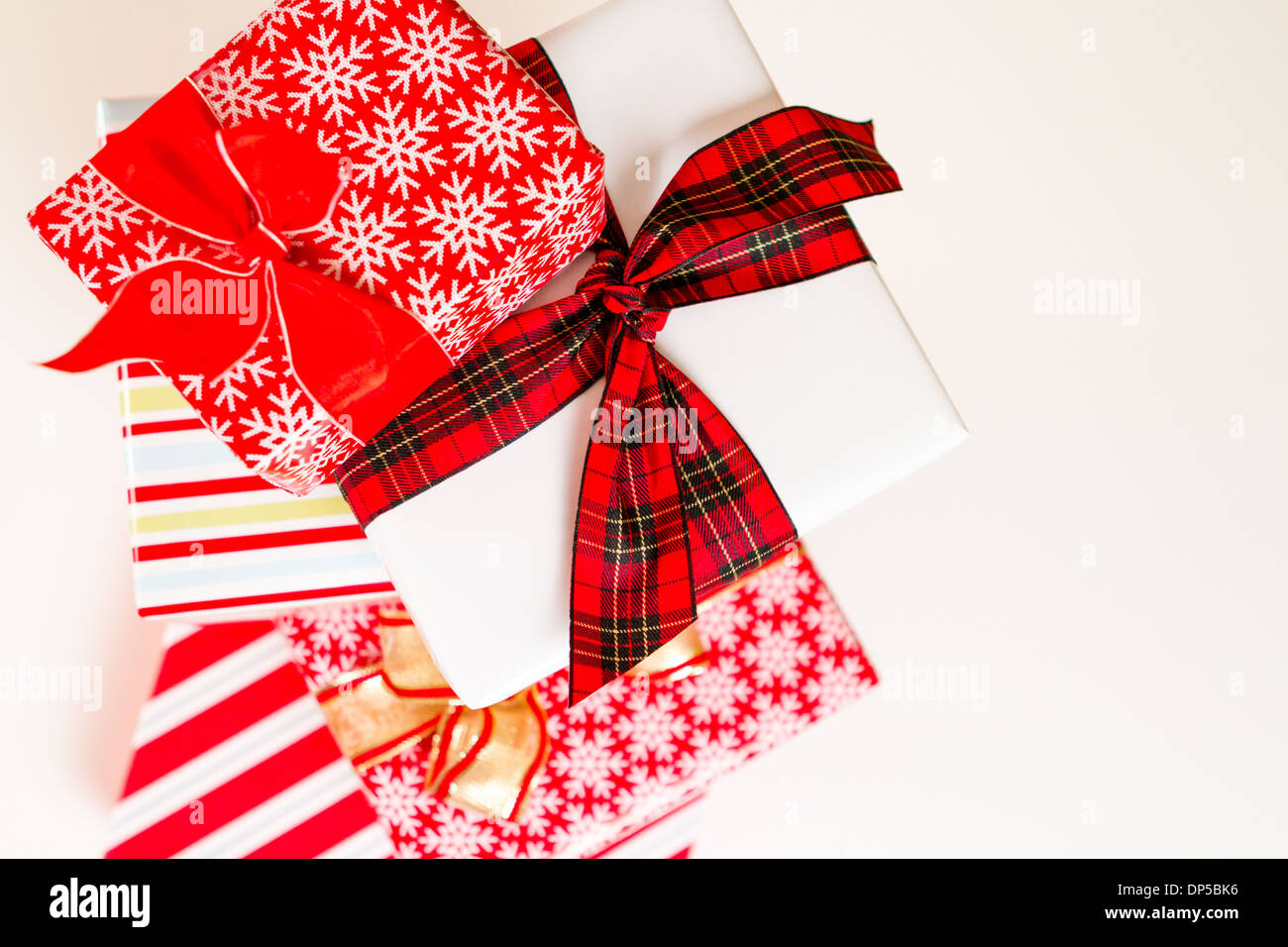Christmas presents wrapped in colorful paper Stock Photo - Alamy