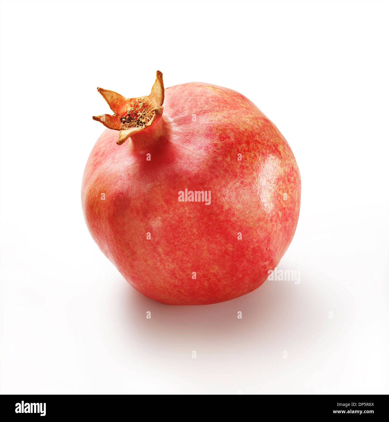 one pomegranate isolated on a white background with shadow Stock Photo ...