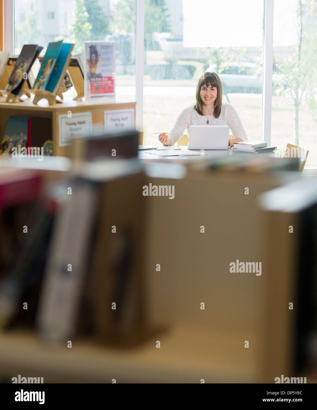 Student With Laptop Studying In Library Stock Photo - Alamy