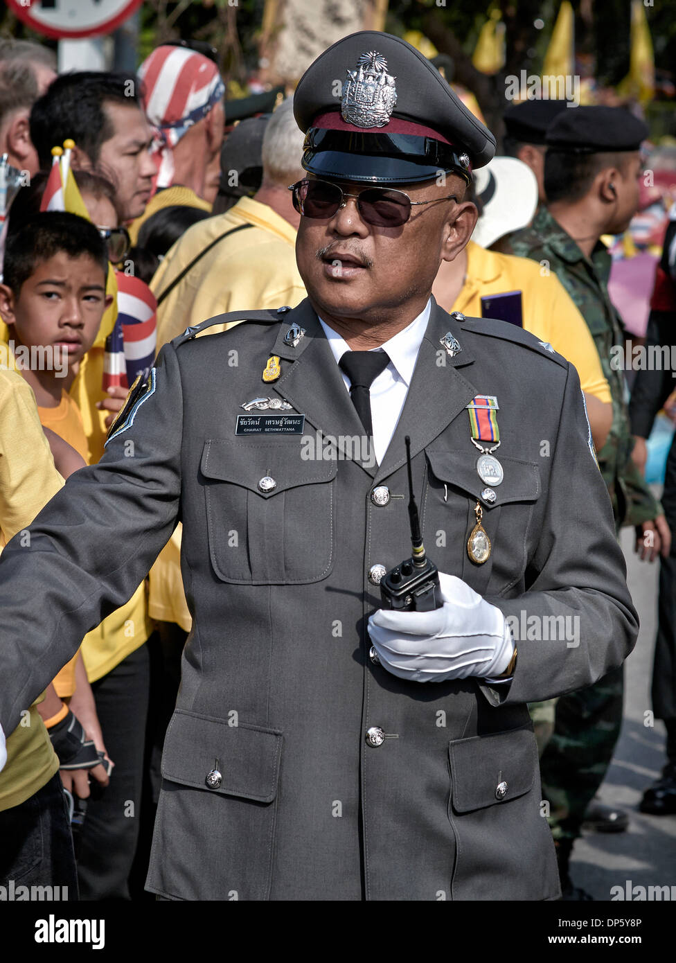 Policeman monitoring crowd control of yellow shirt supporters gatheried ...