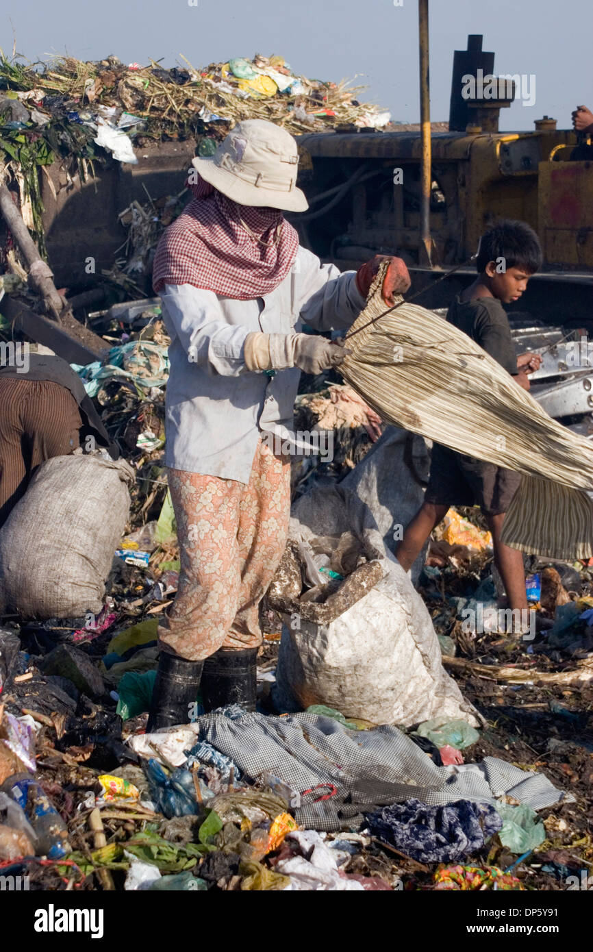 A woman scavenger is collecting recyclable material at the toxic Stung ...