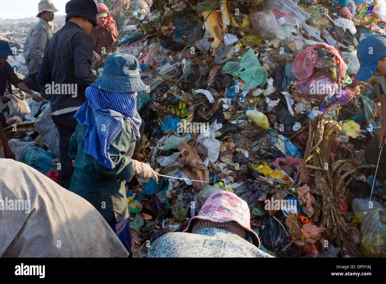 A group of scavengers are collecting recyclable material at the toxic ...