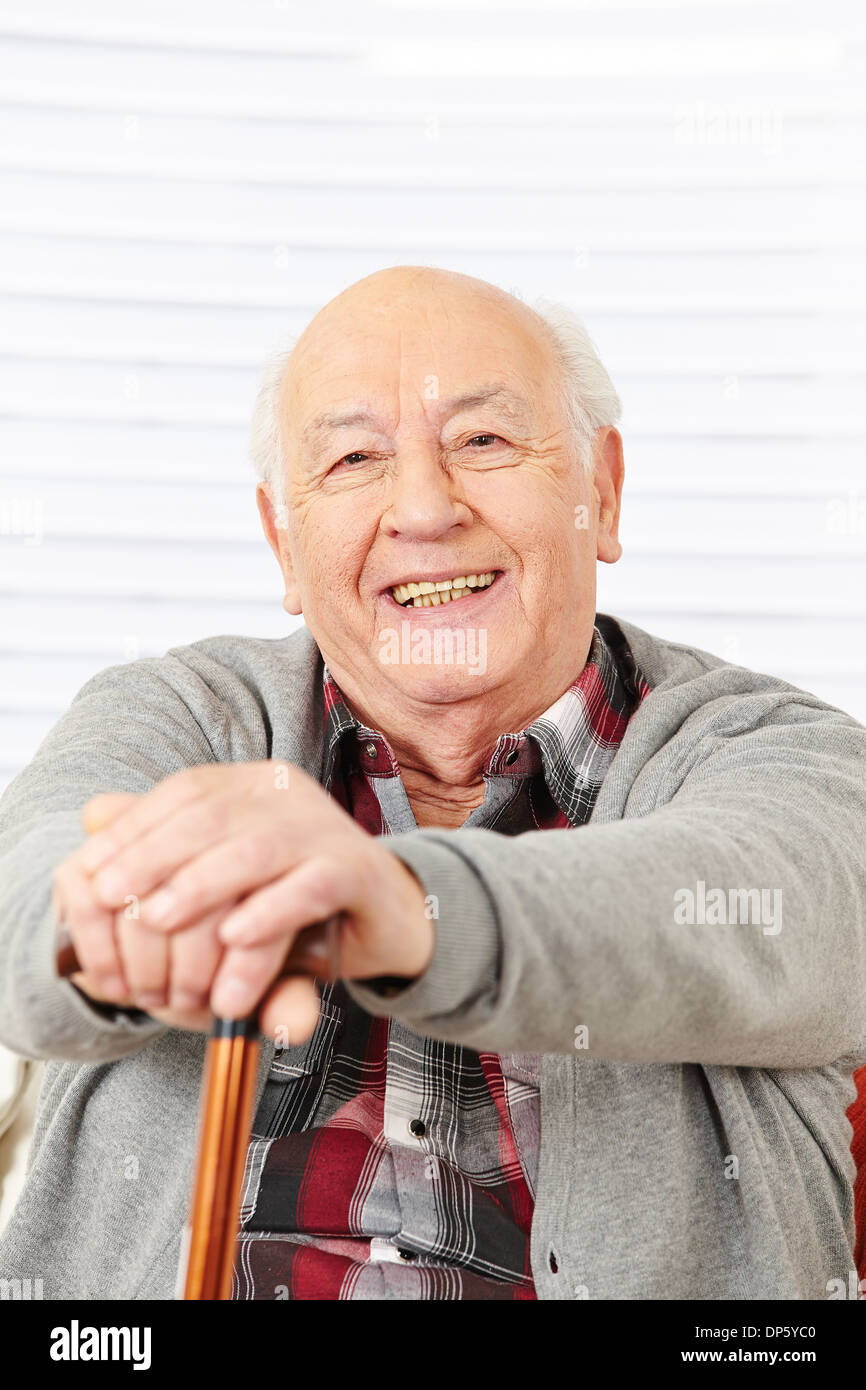 Happy senior citizen man smiling with cane in his hands Stock Photo - Alamy
